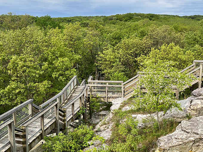 These wooden walkways wind through spring's green canopy like nature's own stairway to serenity and spectacular views.