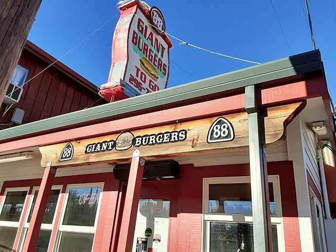 That cheerful red and white exterior isn't just cute—it's a beacon calling hungry travelers to burger salvation.