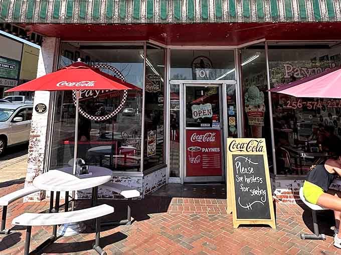 That striped awning and those red umbrellas are practically begging you to sit down and stay awhile.