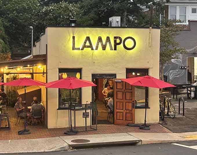 Evening glow at Lampo means one thing: wood-fired magic is happening behind those charming carved doors.