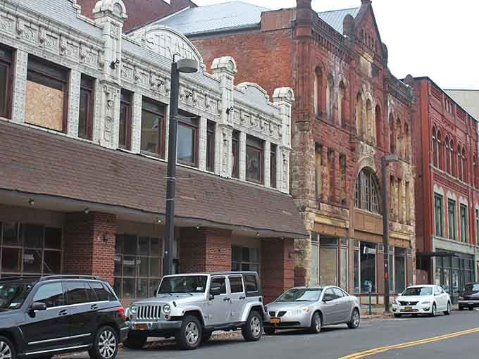 These historic facades tell stories that modern strip malls never could, each brick holding decades of memories.