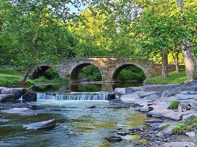 That gorgeous stone arch bridge reflecting in the creek? That's your destination, and it's absolutely worth the drive.