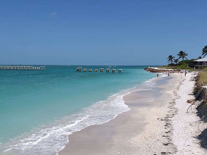 That impossibly white sand meets crystal-clear Gulf waters, with weathered pier pilings adding character to this peaceful, uncrowded paradise.
