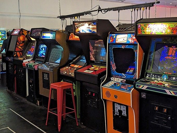 A lineup of retro arcade cabinets stands ready for action, offering nostalgic gaming breaks between your pinball conquests at this Frederick treasure.