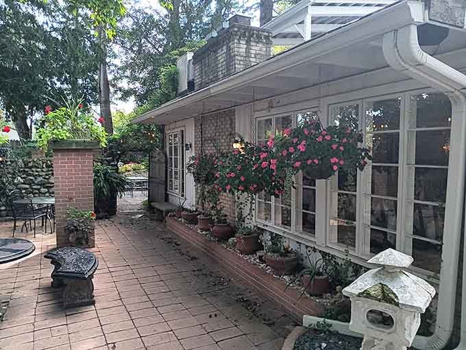 Pink blooms frame white windows like nature's own welcome committee at this charming Morristown treasure.