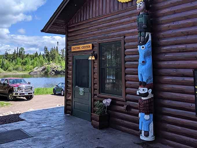 The Nature Center entrance features colorful totem pole art and stunning lake views that hint at the adventures waiting inside.