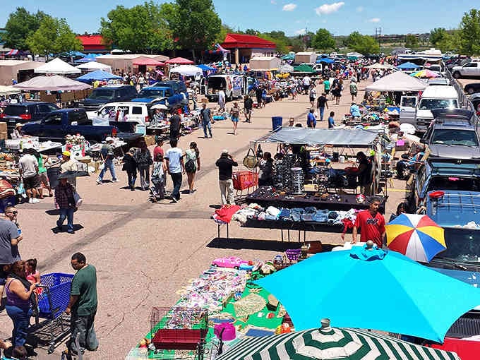 The outdoor market sprawls like a small city of deals, where colorful umbrellas shade bargains under Colorado's endless sky.