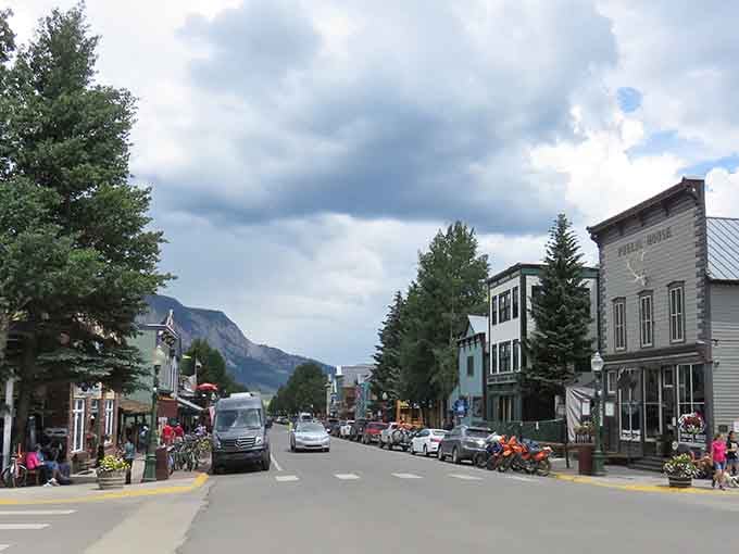 Where historic buildings wear their colors proudly and the peaks stand guard like nature's own security system.