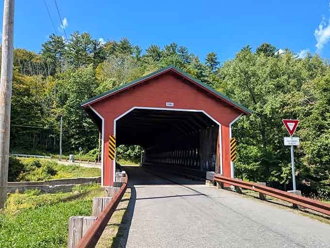 That cheerful red exterior isn't just pretty, it's been welcoming travelers across the Ware River for over a century.