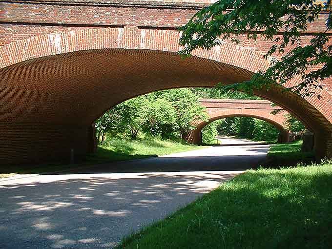 Drive under beautiful historic brick bridges on this scenic route, where lush greenery and timeless charm line every single mile.