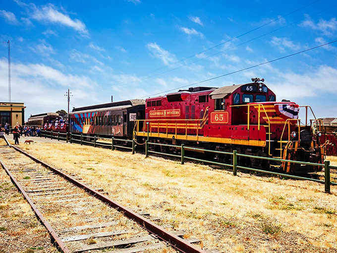 The red motorcar gliding over sandy roads proves that sometimes the best views require absolutely zero hiking effort.