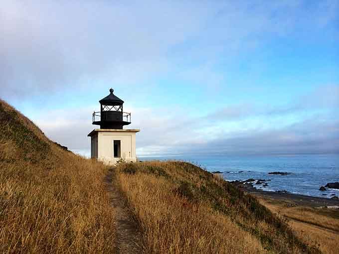 Perched on its bluff like a lonely sentinel, this lighthouse has been watching ships pass for over a century.