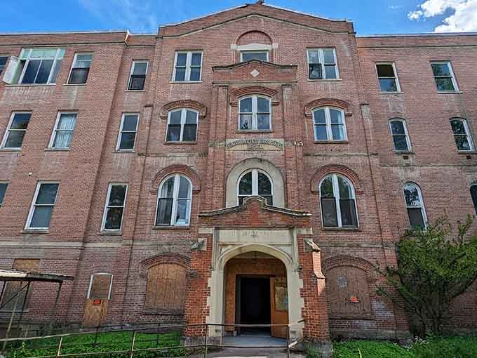 That imposing brick facade and arched entrance once welcomed patients, now it just welcomes goosebumps and ghost stories.