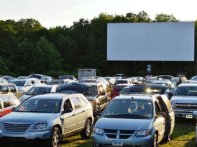 The blank screen awaits its nightly transformation, surrounded by vehicles that become front-row seats to cinematic magic at twilight.