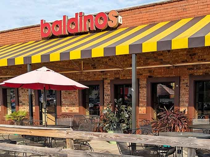 The outdoor seating area proves that sometimes the best dining experiences happen at a picnic table under an umbrella.