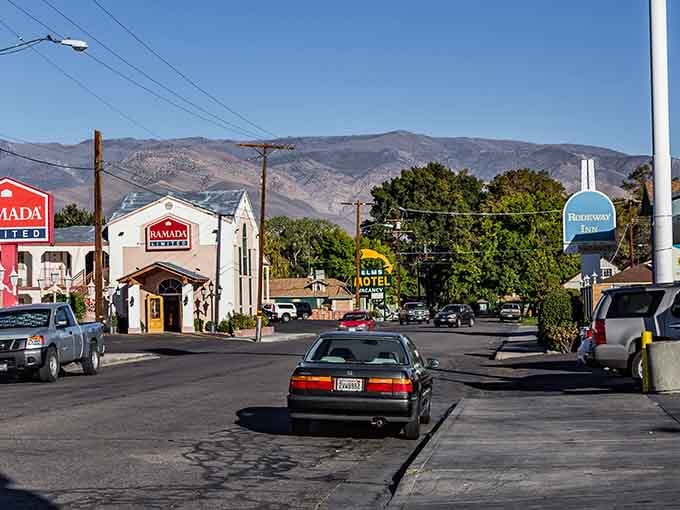 Main Street Bishop stretches out beneath mountain peaks that make your daily commute look like a joke.
