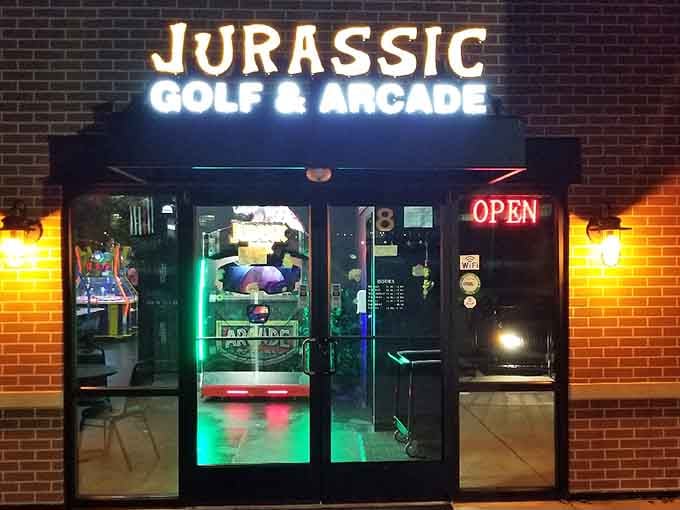 That neon glow through the storefront promises adventure, and those colorful lights inside deliver pure prehistoric joy.