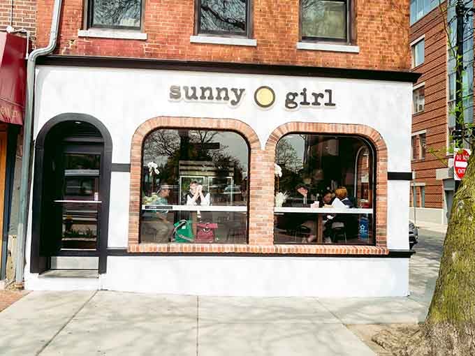 That white-and-brick facade with those cheerful arched windows is your beacon to breakfast bliss in Roslindale.