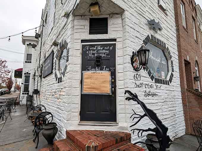 The white-painted brick exterior of Annabel Lee Tavern features Gothic artwork that hints at literary adventures within.