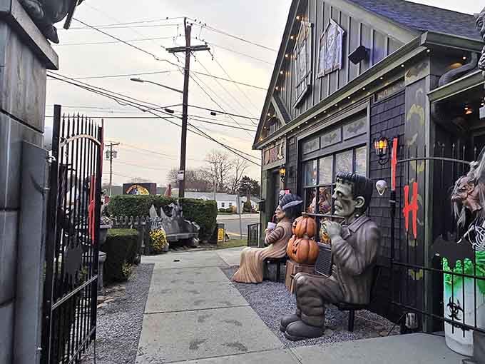 Even in daylight, Frankenstein's monster casually holds pumpkins outside, proving this place commits to the spooky theme around the clock.