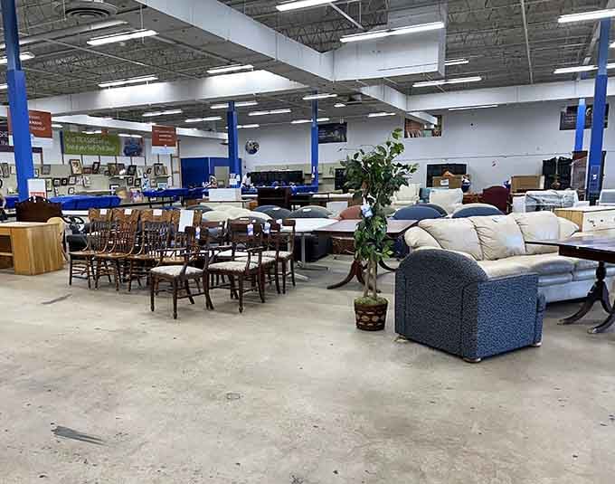 The warehouse-style layout stretches before you like a treasure map, with blue columns marking your path through furniture paradise.
