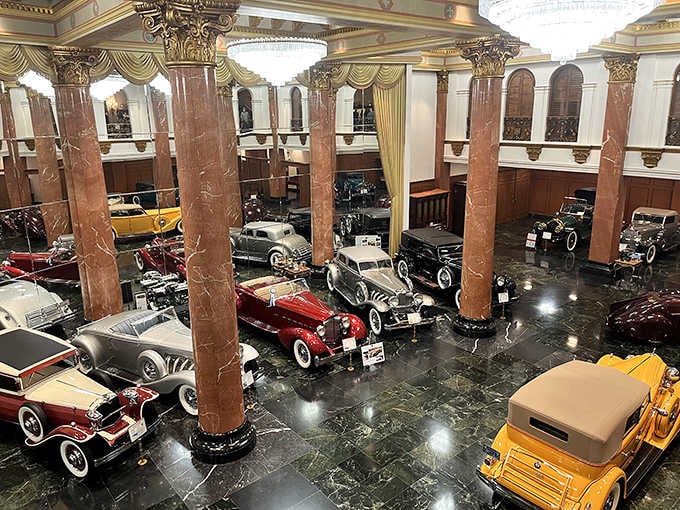 This grand hall makes most people's garages look like they're storing lawn equipment instead of automotive history.