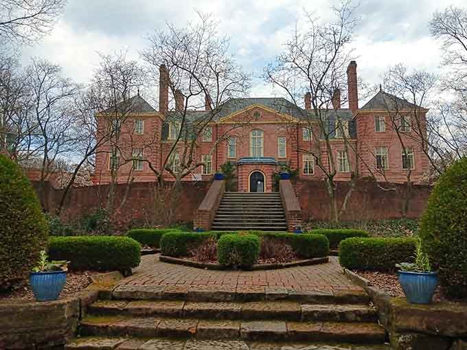 Even in early spring, the mansion's impressive architecture shines through, with its grand staircase and elegant design promising beautiful gardens waiting to bloom soon.
