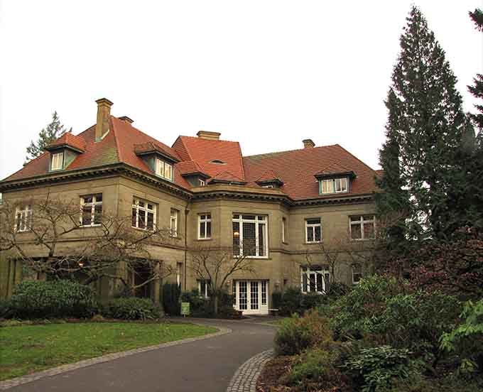 That distinctive red tile roof against Portland's evergreen backdrop creates a scene straight out of a European fairy tale, minus the dragon.