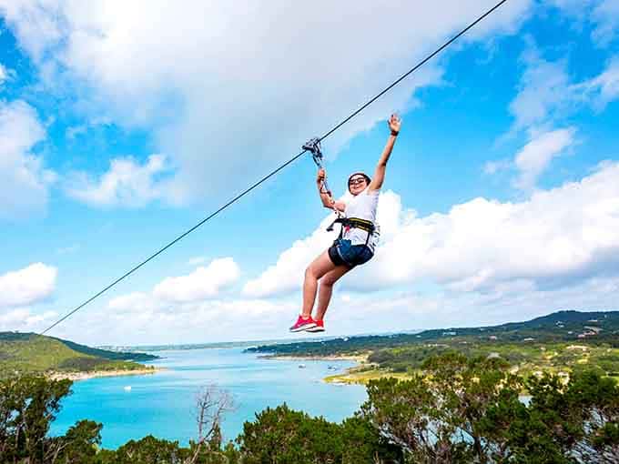 Victory wave from above the clouds, where Lake Travis becomes your personal backdrop for life's greatest adventure selfie.