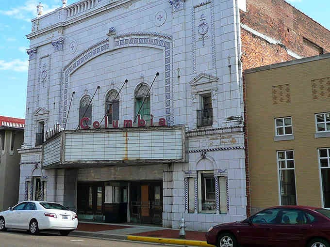 The Columbia Theatre's ornate white facade stands as a stunning reminder that small towns once built entertainment palaces with serious style.