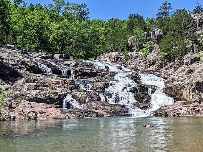 Rocky Falls tumbles 40 feet down ancient volcanic rock, offering stunning views and cool swimming holes for adventurous Missouri visitors.