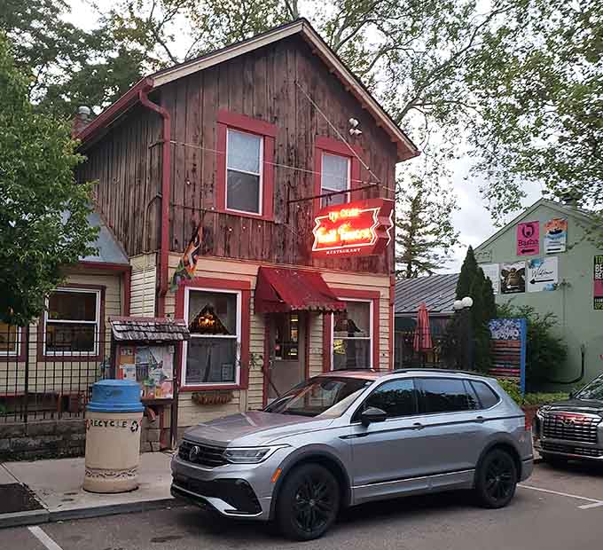 That weathered wood and glowing neon sign aren't trying to look old, they've earned every gorgeous year of patina.
