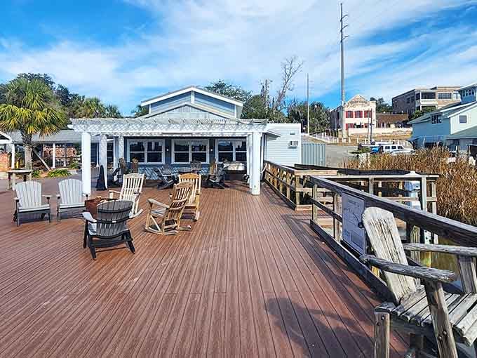 This deck is where magic happens: fresh seafood, marsh views, and enough comfortable seating to make you forget you ever had responsibilities.