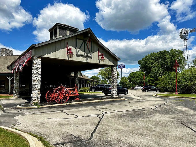 Stone pillars and vintage farm equipment frame the entrance like a portal to comfort food paradise.