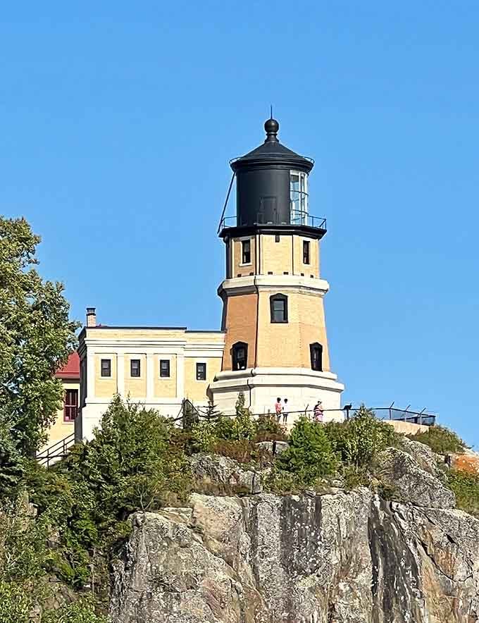 The lighthouse stands sentinel on its rocky throne, proving that the best views require the most dramatic real estate choices.