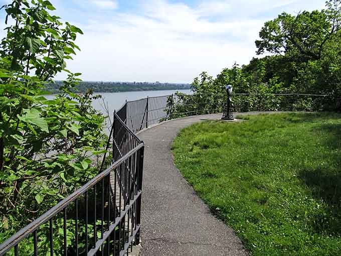 That gentle curve in the railing follows the natural contours of the cliff, leading your eyes straight to the river below.