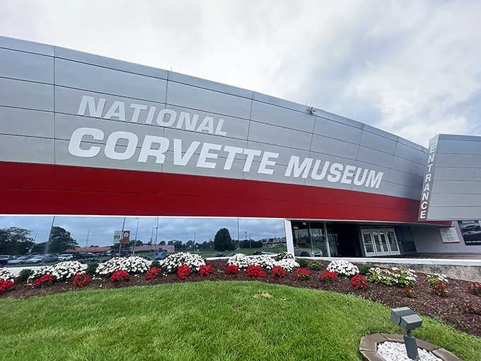 That bold red stripe wrapping around the building announces this temple to American automotive dreams from miles away.
