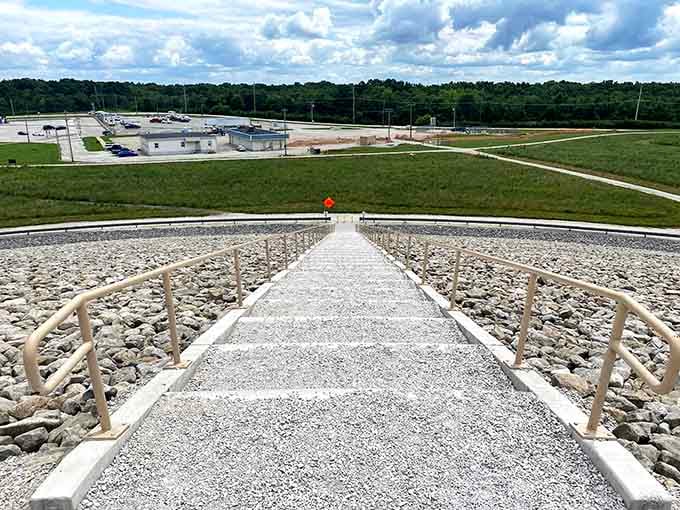 Standing atop the disposal cell, you'll see the interpretive center below and conservation lands stretching toward forested horizons beyond.