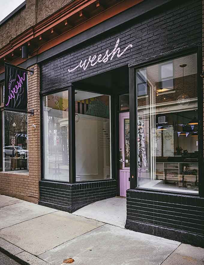 The entrance of Weesh Bake Shop, with its purple sign, hints that something deliciously fun is happening inside this Roslindale gem.