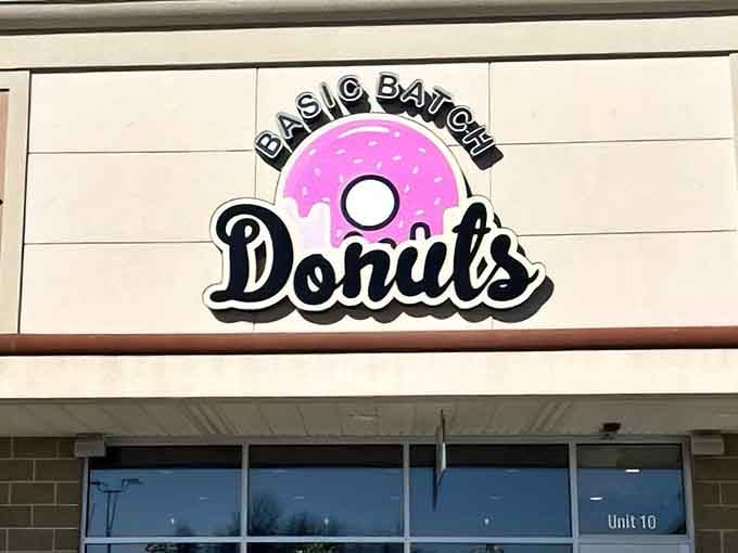 That cheerful pink donut logo at Basic Batch Donuts promises exactly what's waiting inside: pure happiness.