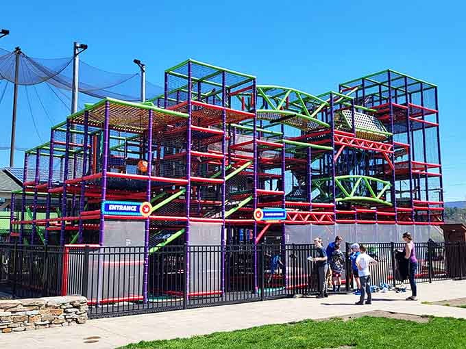 This towering playground structure reaches skyward in brilliant colors, promising adventure at every level for climbers.