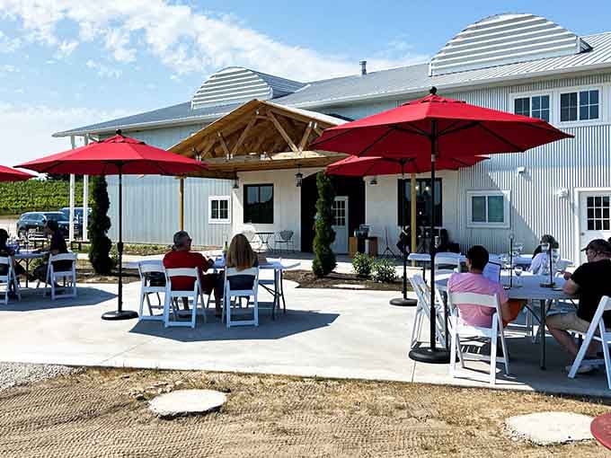 Those crimson umbrellas against the white farmhouse exterior create a scene straight out of a Tuscan postcard, minus the jet lag.