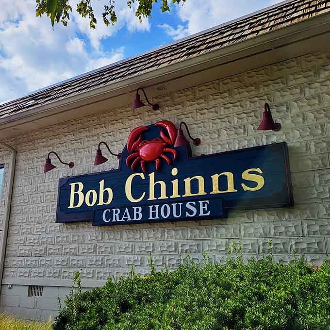 That cheerful crab beckons you inside where ocean-fresh flavors await in landlocked Illinois, proving geography means nothing.