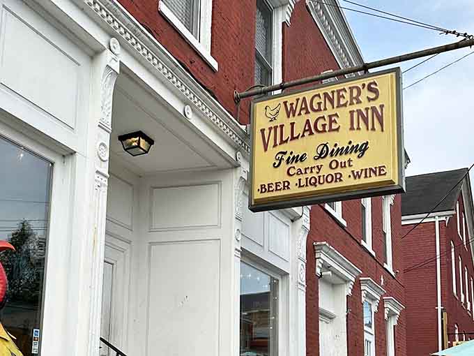 That yellow sign isn't just pointing you toward dinner; it's pointing you toward some of the finest fried chicken in the entire state.