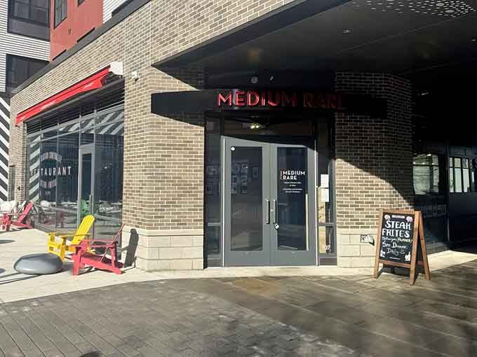 That glowing red sign beckons like a beacon for carnivores, promising steak salvation in the heart of Watertown.