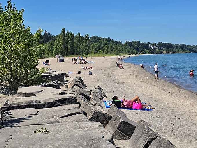 Summer beach day in full swing with actual sand, actual water, and people who can't believe this is actually Ohio.