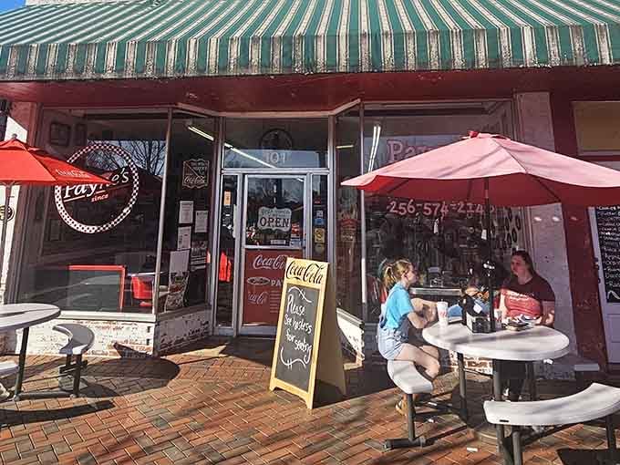 That striped awning and those red umbrellas are practically begging you to sit down and stay awhile.