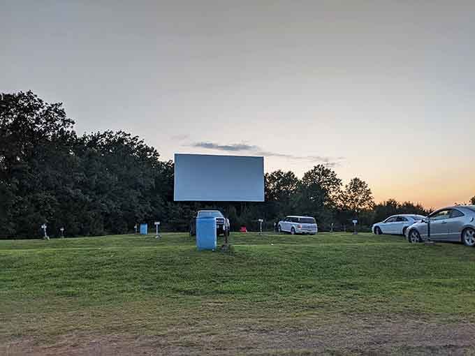 Evening descends on the lot where families gather to prove that sometimes the best seat is your own.