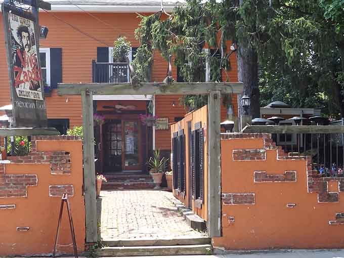 That orange wall isn't just paint, it's a promise that something delicious awaits beyond that rustic gateway.