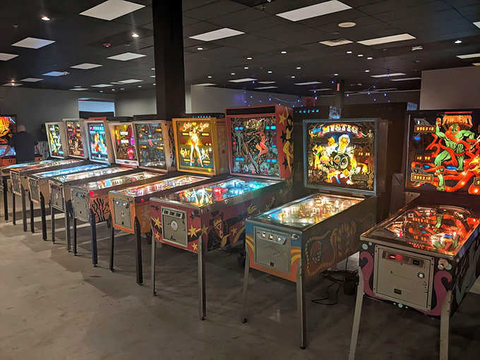 Rows of vintage pinball machines stand ready like soldiers of joy, waiting to light up your afternoon.
